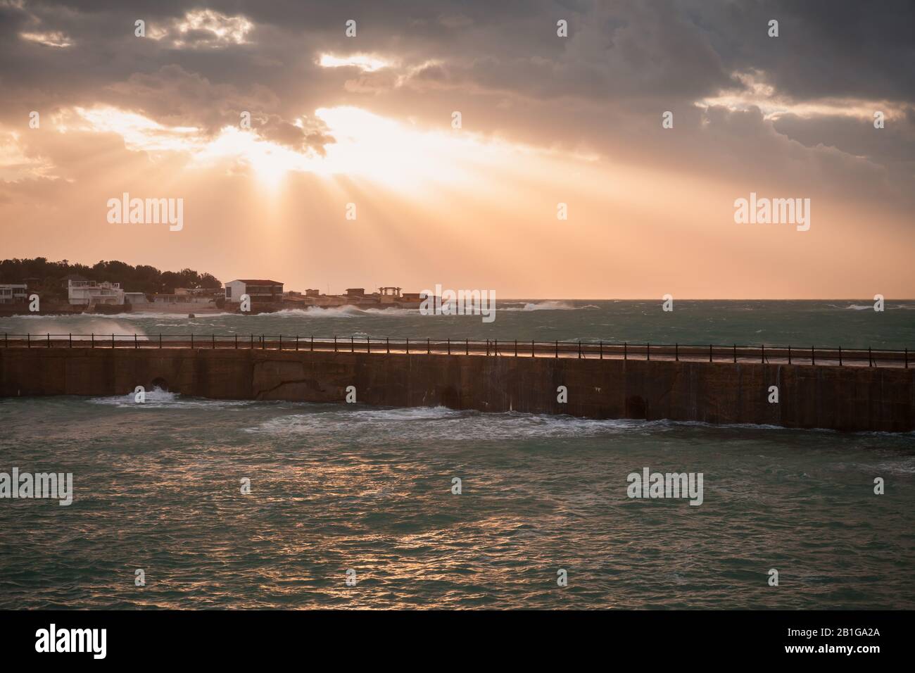 Montazah beach evening landscape with sunlight and stormy sea water ...