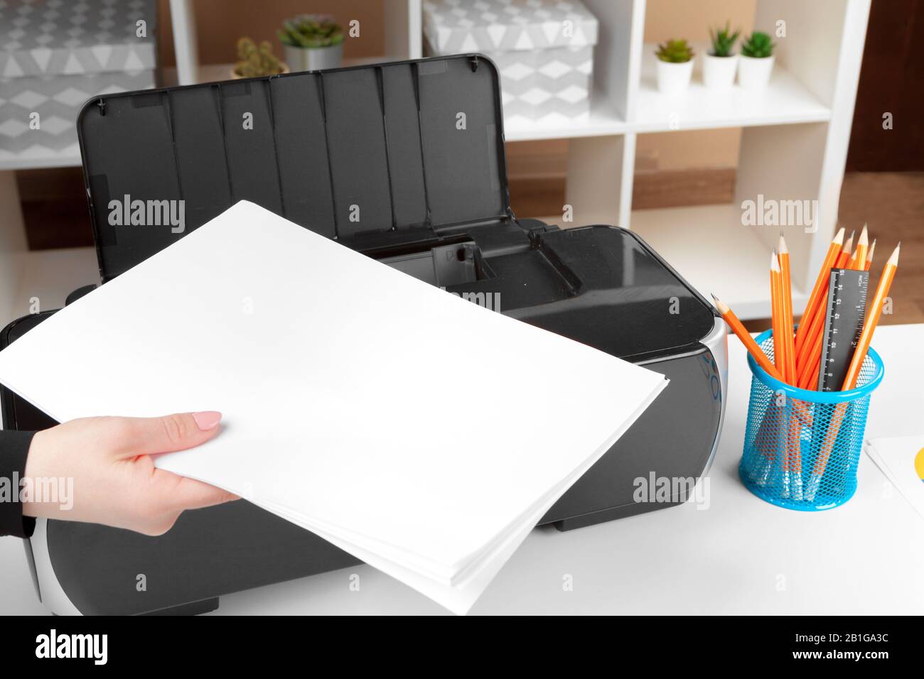 Woman using the printer to scanning and printing document Stock Photo ...