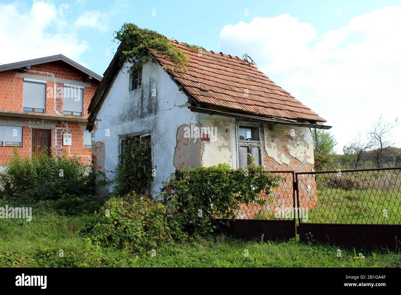 Very small abandoned old red brick family house ruins with broken ...