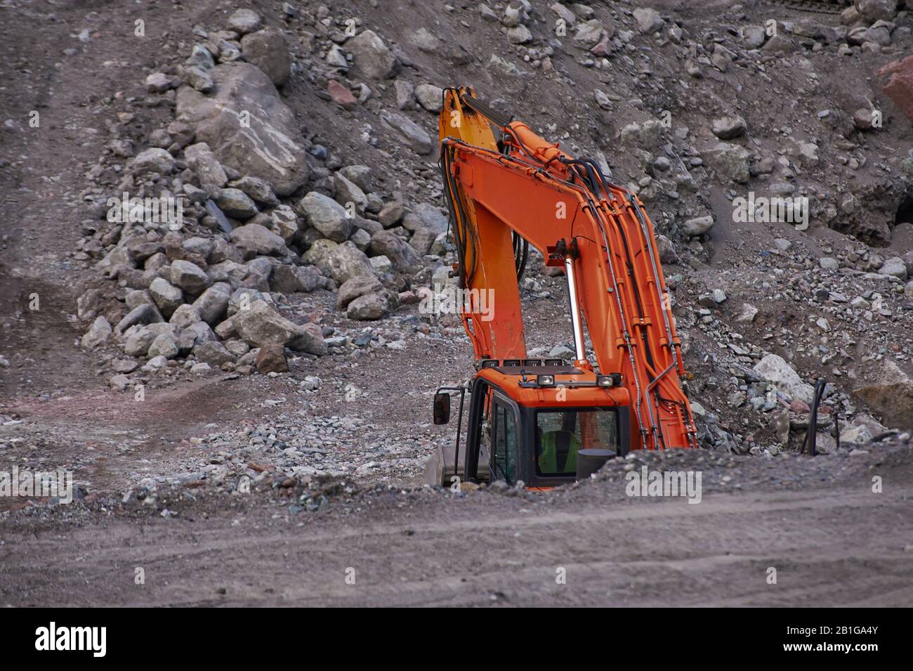 Excavator digging ground in the mountains Stock Photo - Alamy