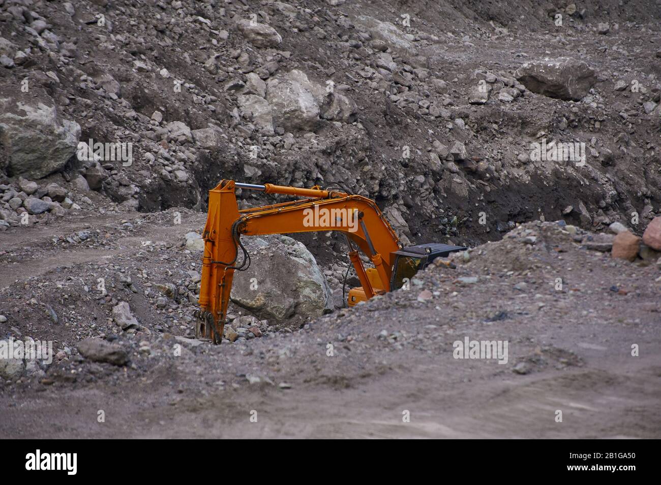 Excavator digging ground in the mountains Stock Photo - Alamy