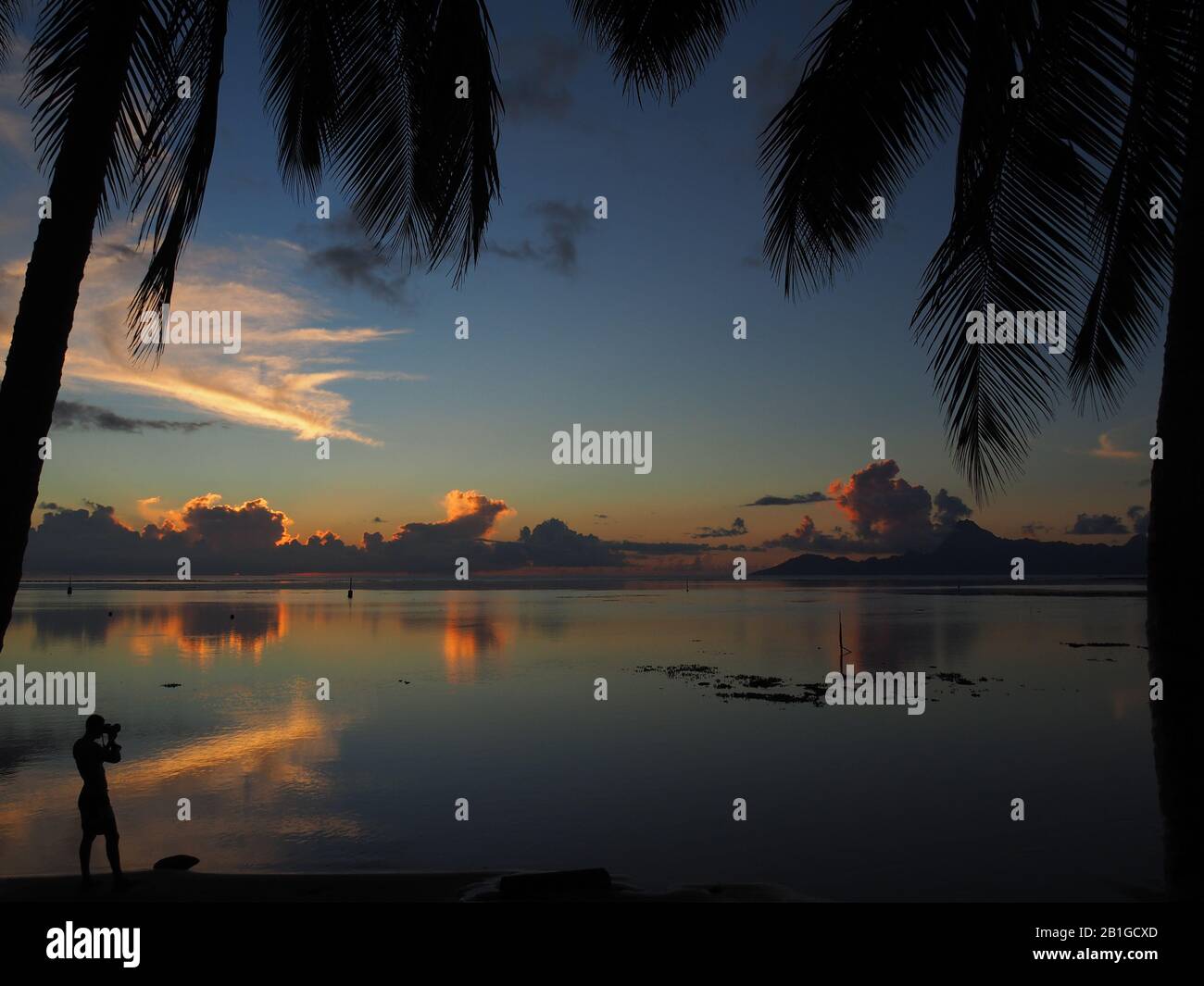 Tahiti South Seas sunset with photographer Stock Photo - Alamy