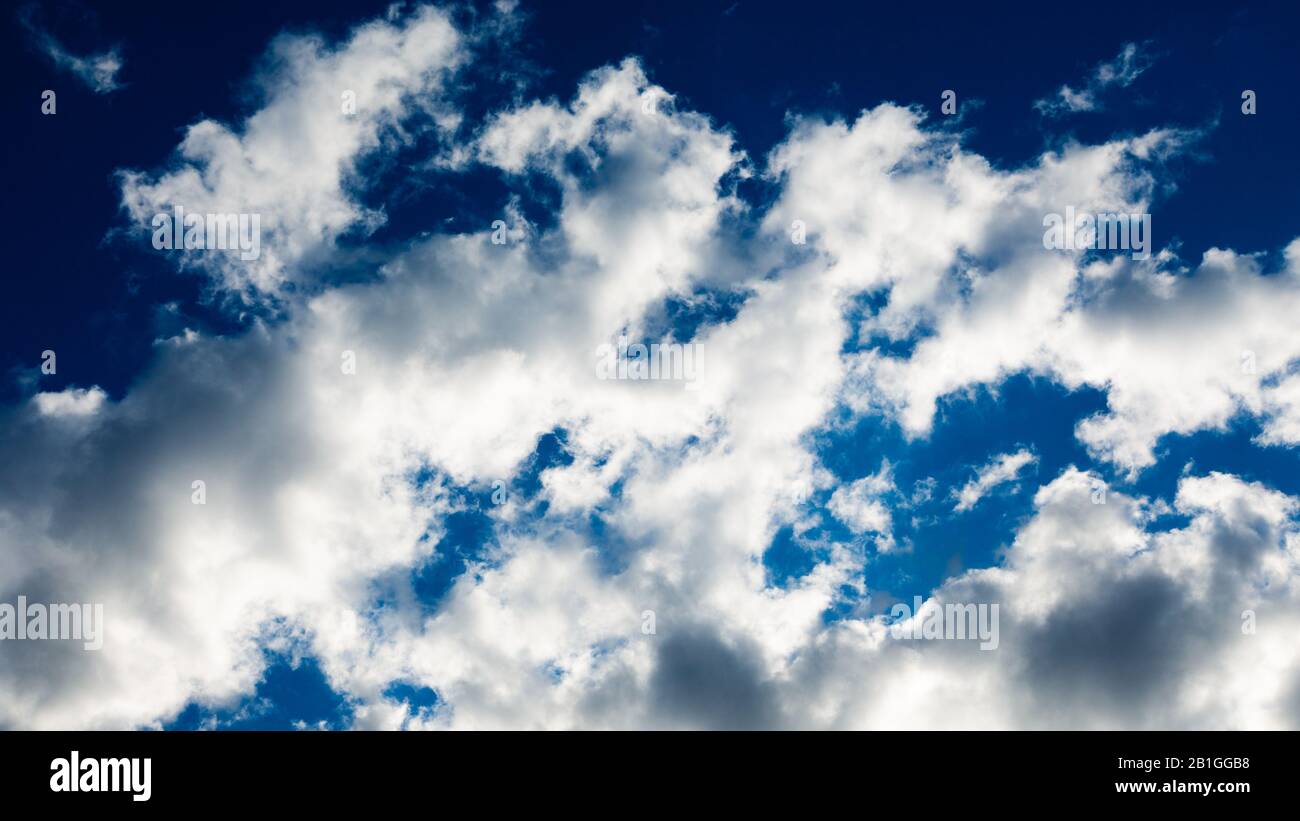 blue sky background with white clouds. wallpaper for your device Stock Photo - Alamy