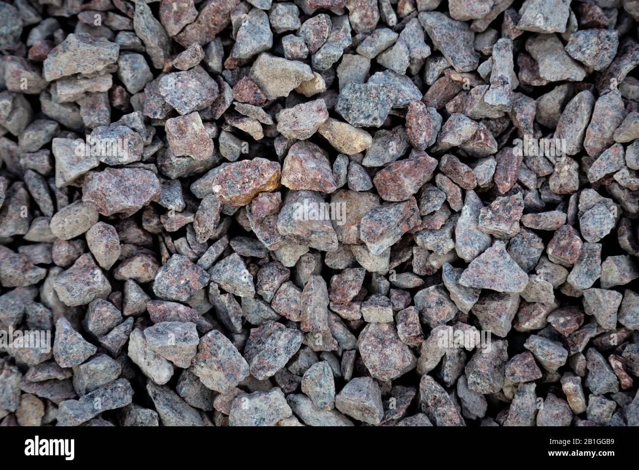 Crushed grey stone on the ground texture background Stock Photo - Alamy
