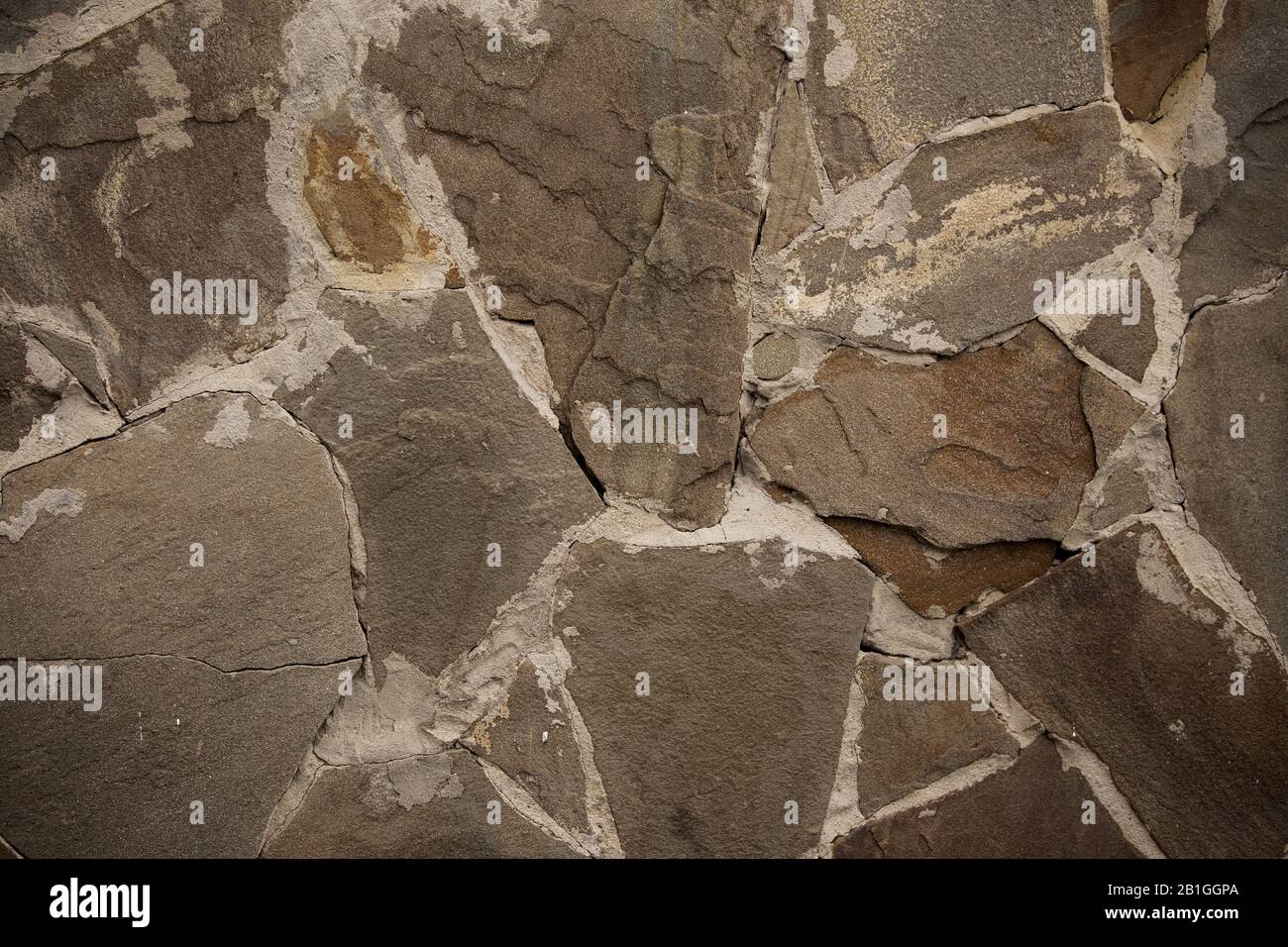 Fragment of a wall from a chipped stone. Wall stone background Stock ...