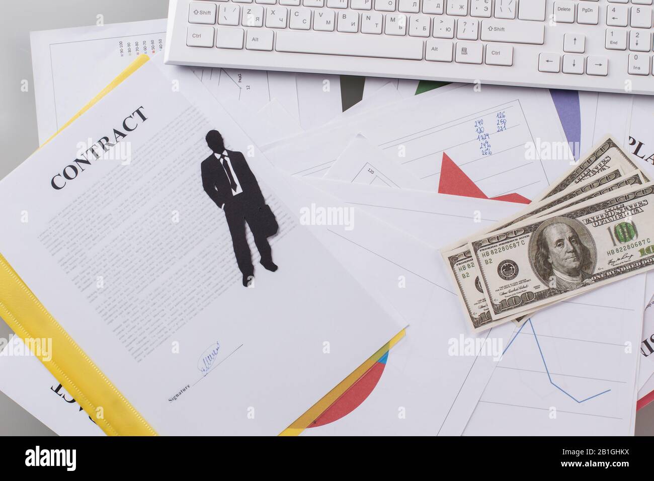 Money on signed papers Stock Photo - Alamy