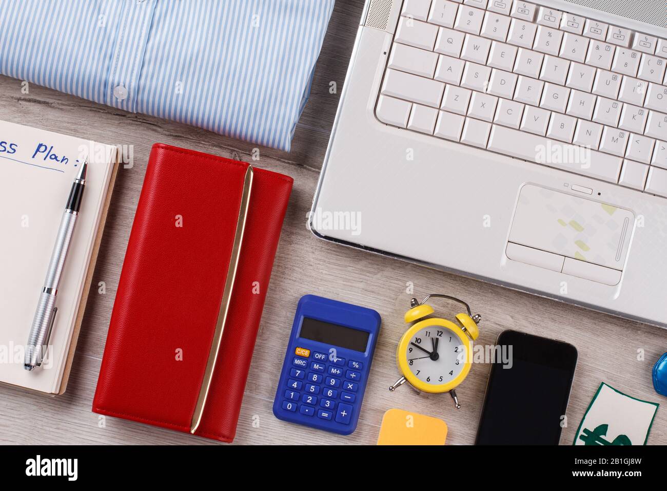 Wallet, pocket calculator and clock Stock Photo - Alamy