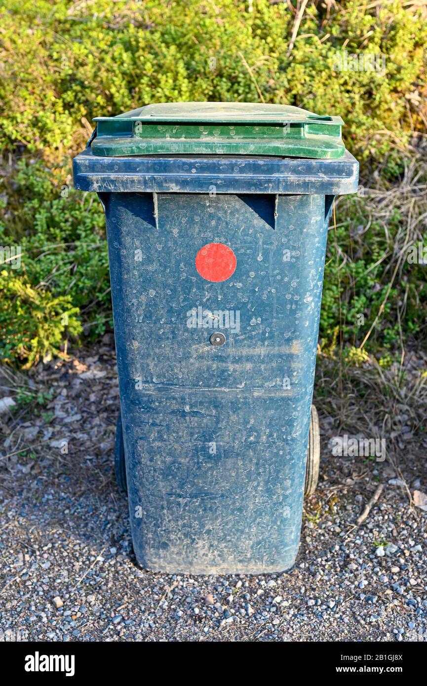 gabage can standing near a gravel road Stock Photo - Alamy