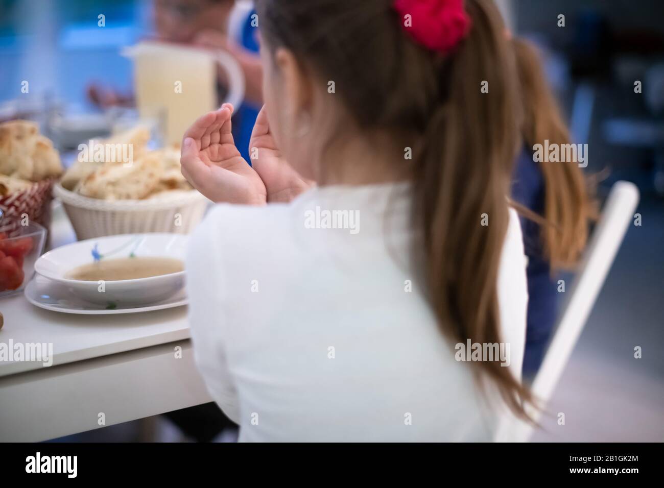 Eid Mubarak Muslim people praying before iftar dinner. Eating ...