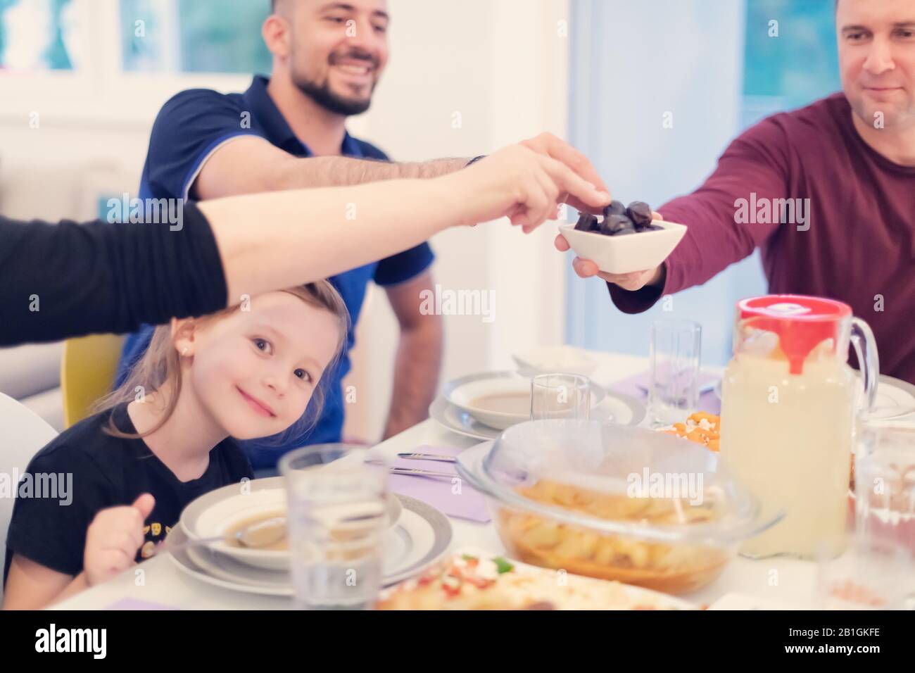 Eid Mubarak Muslim family having Iftar dinner eating dates to break ...