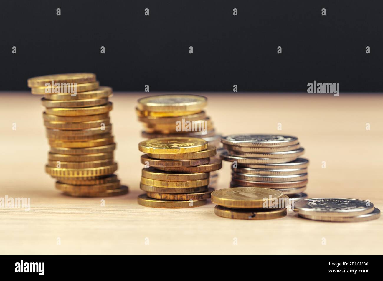 piles of coins on working table. Creative photo Stock Photo - Alamy