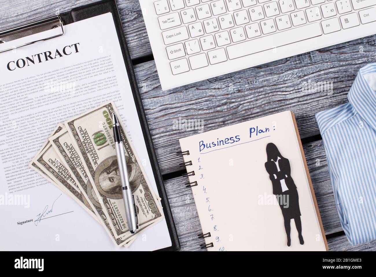 Signed contract with american dollars Stock Photo - Alamy
