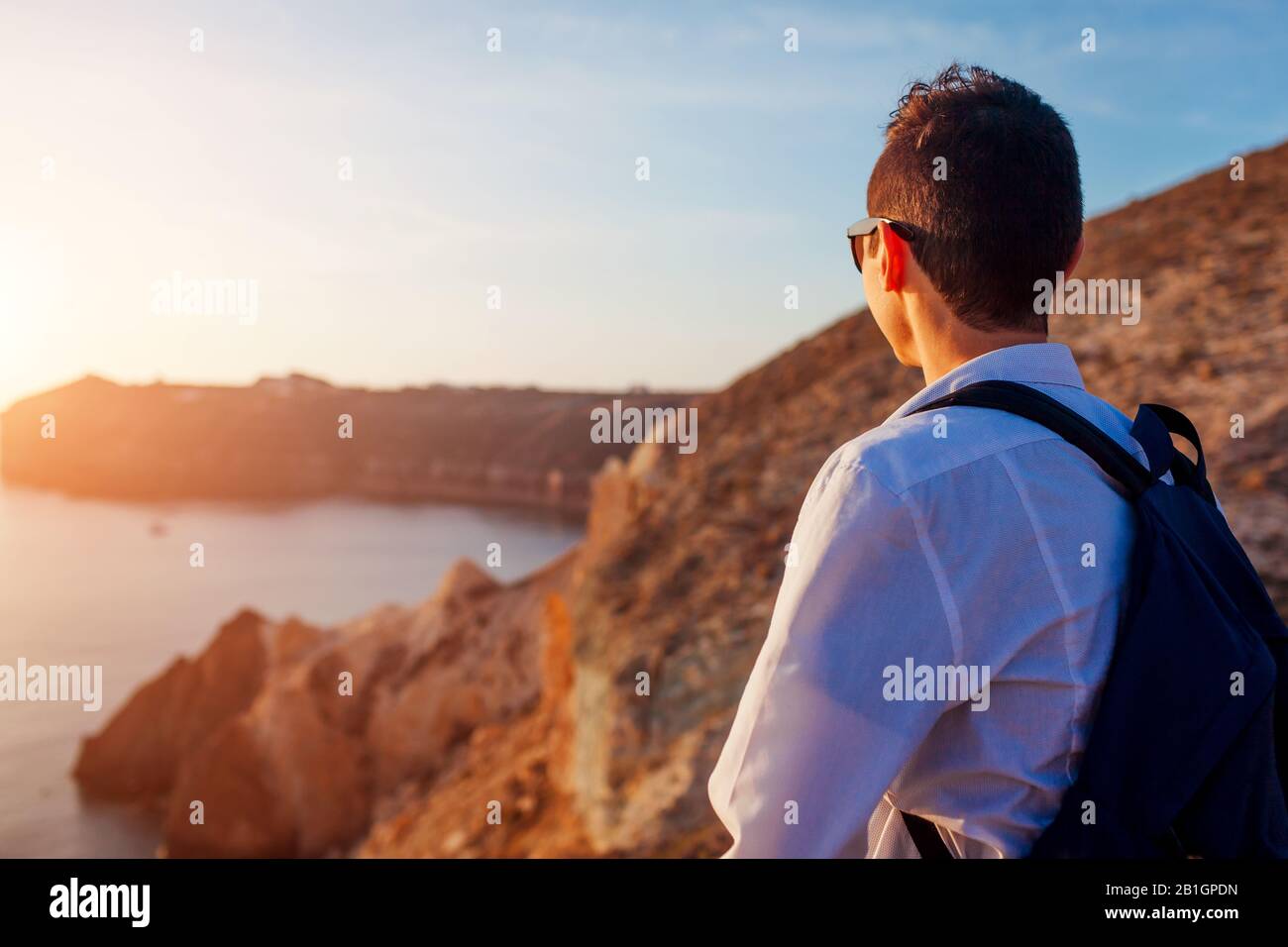 Tourist walking by White beach on Aegean sea Santorini island Greece ...