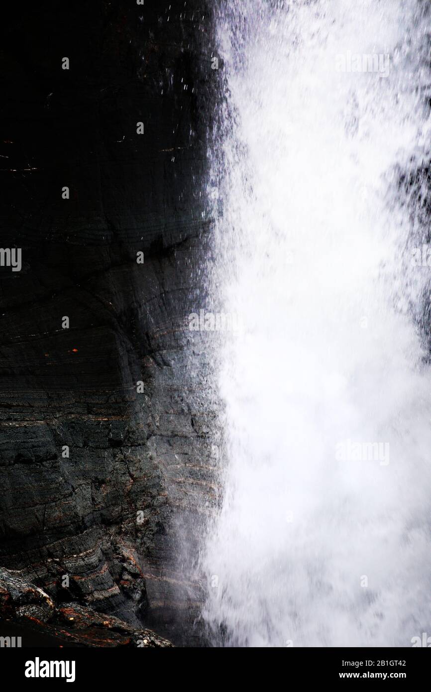 Waterfall detail with dark rock cliff and bright spray Stock Photo - Alamy