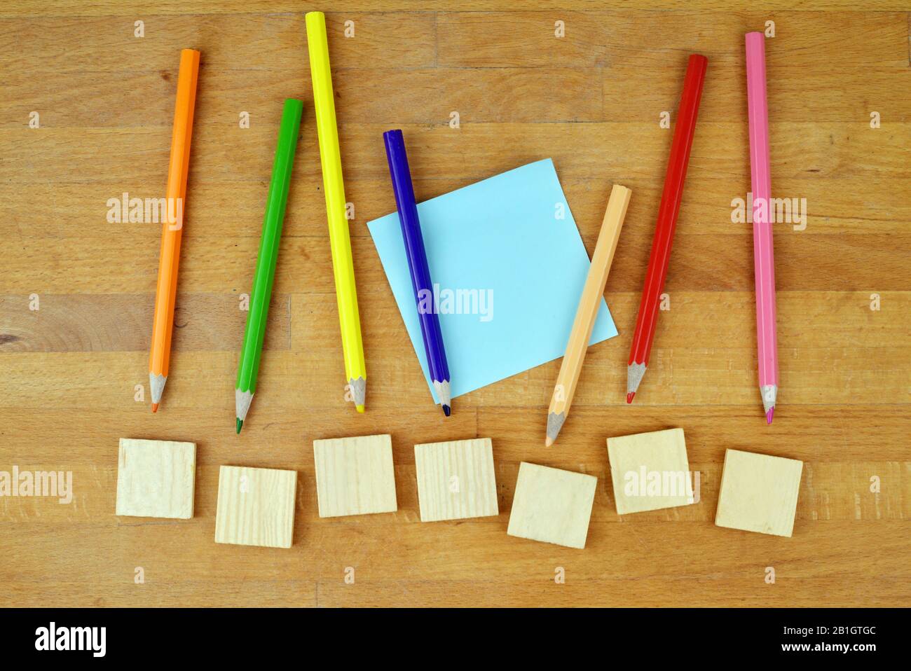 Creative concept, table with colorful pencils paper notice and wooden ...