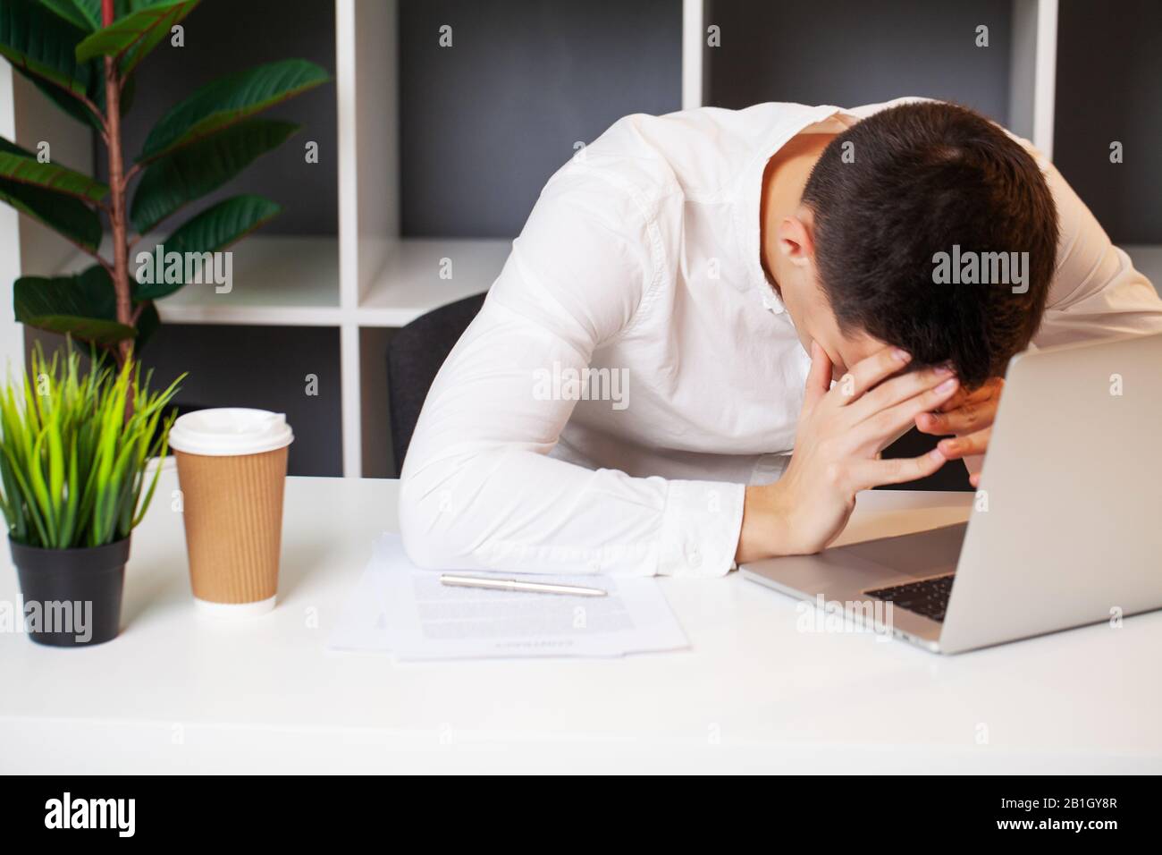 Angry businessman sits desk hi-res stock photography and images - Alamy