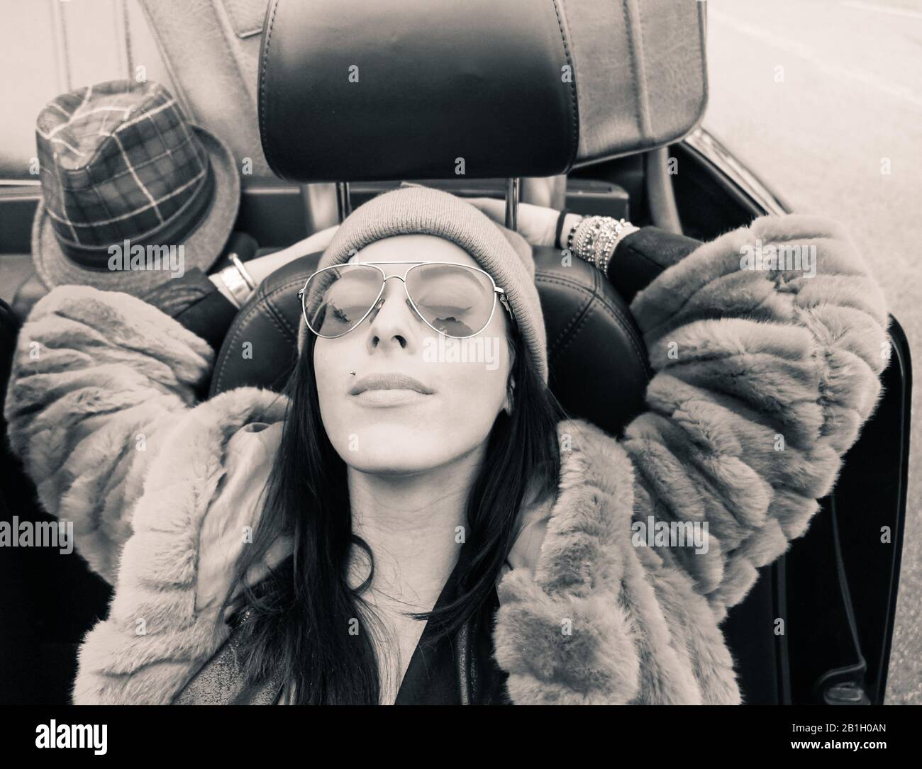 Fashion portrait of young woman relaxing in cabriolet roadster auto ...