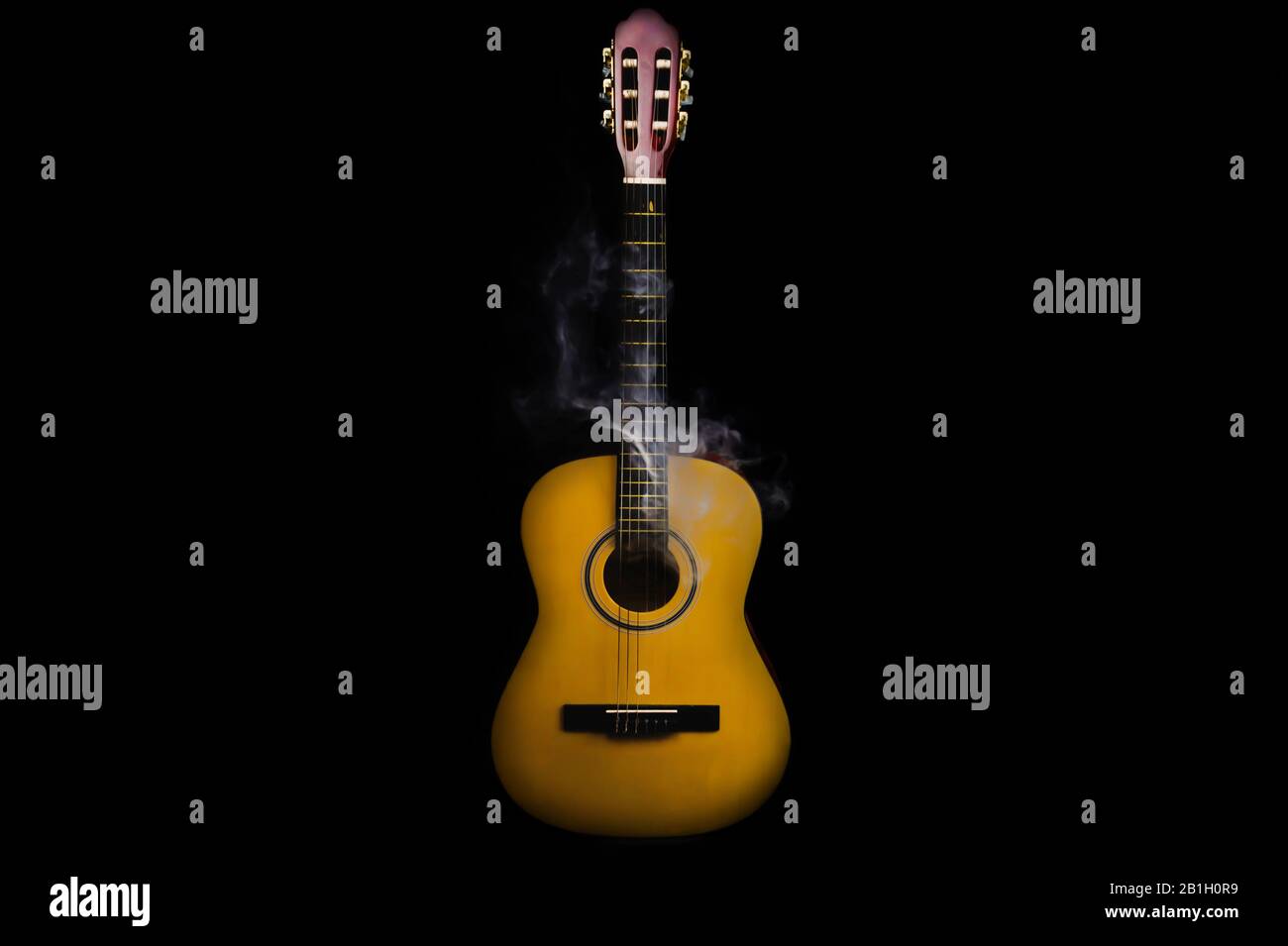 Guitar in smoke on the black background. acoustic musical instrument ...