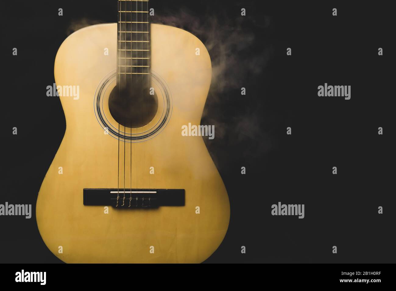 Guitar in smoke close up. acoustic musical instrument. strings on the ...