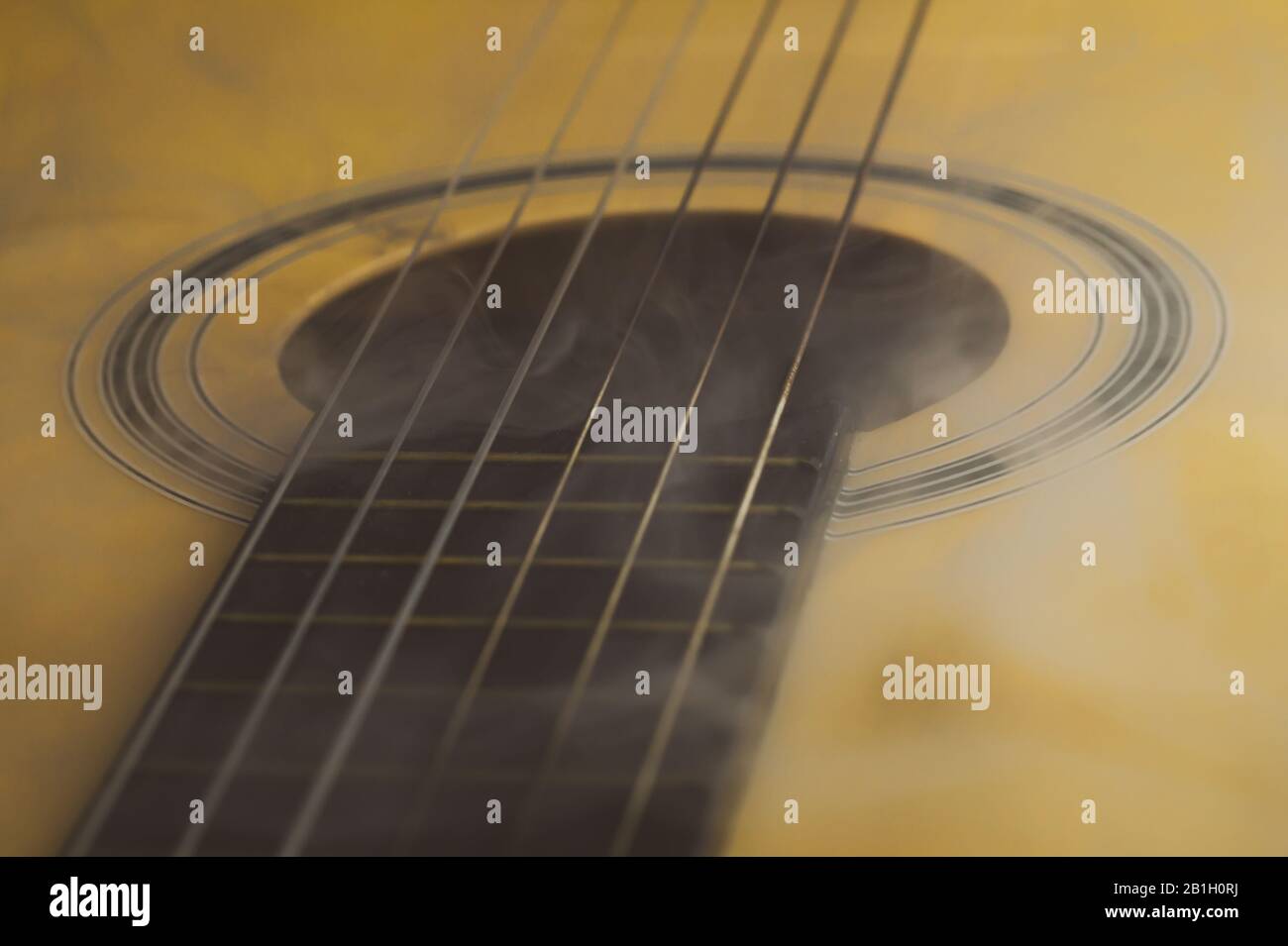 Guitar in smoke close up. acoustic musical instrument. strings on the ...