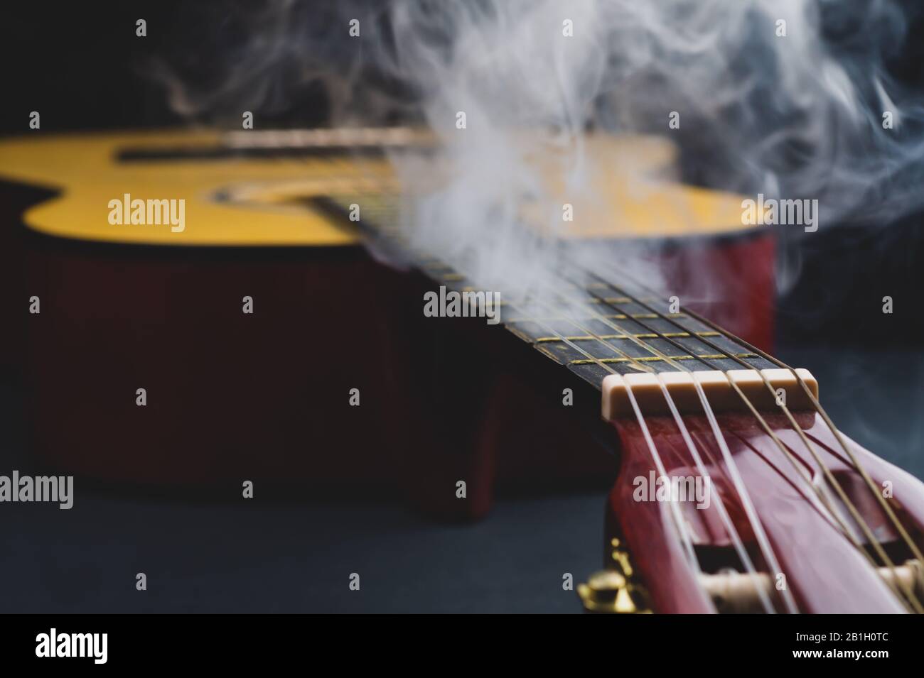 Guitar in smoke close up. acoustic musical instrument. strings on the ...