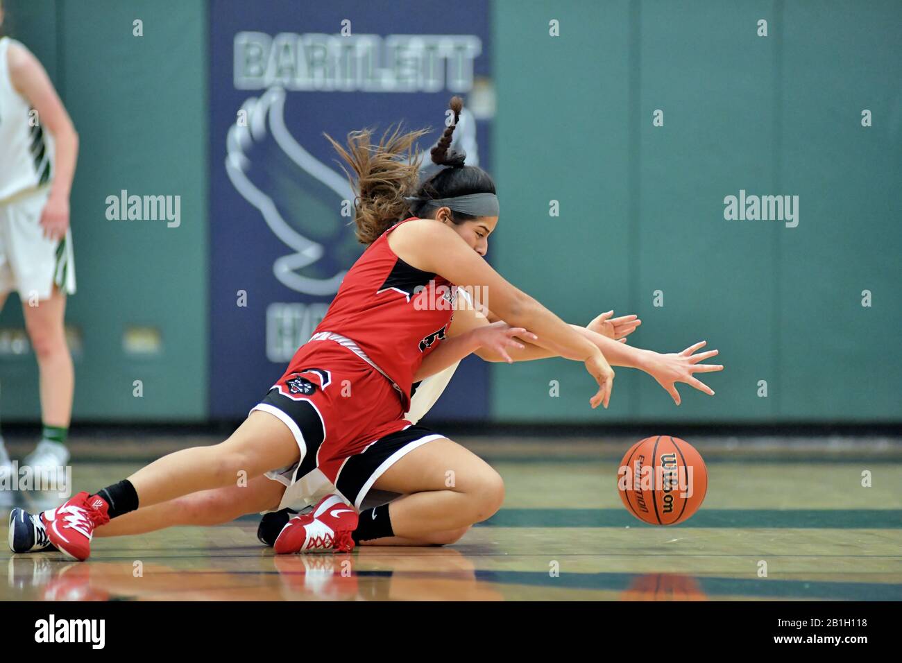 Opposing players diving to the floor in an effort to control a loose ...