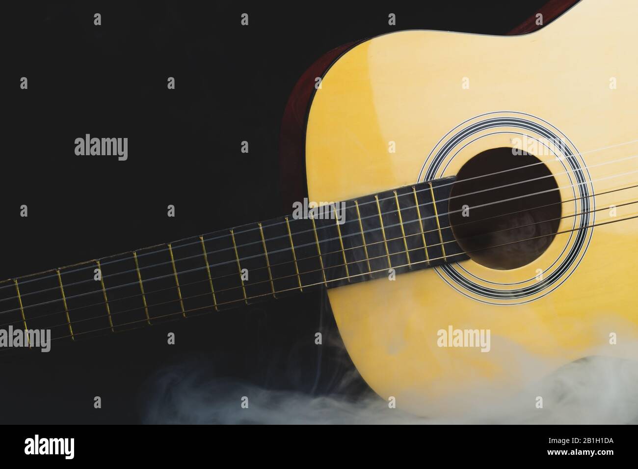Guitar in smoke on the black background. acoustic musical instrument ...