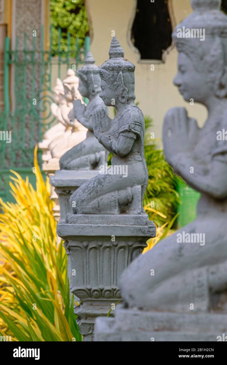 Cambodia, Phnom Phen - Mar 2016: Line up of praying Buddha statues ...