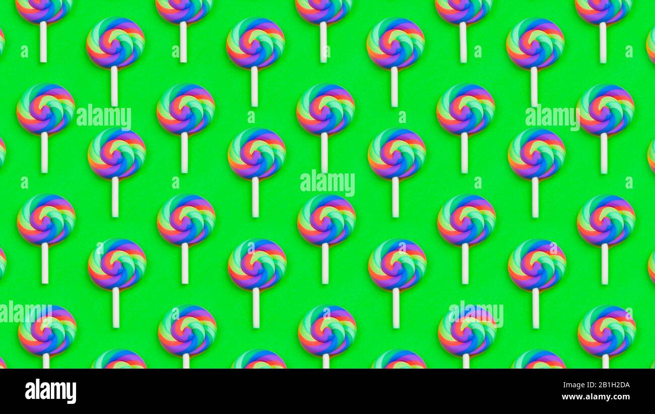Candy pattern. lollipops are in a row. lots of sweets on green ...