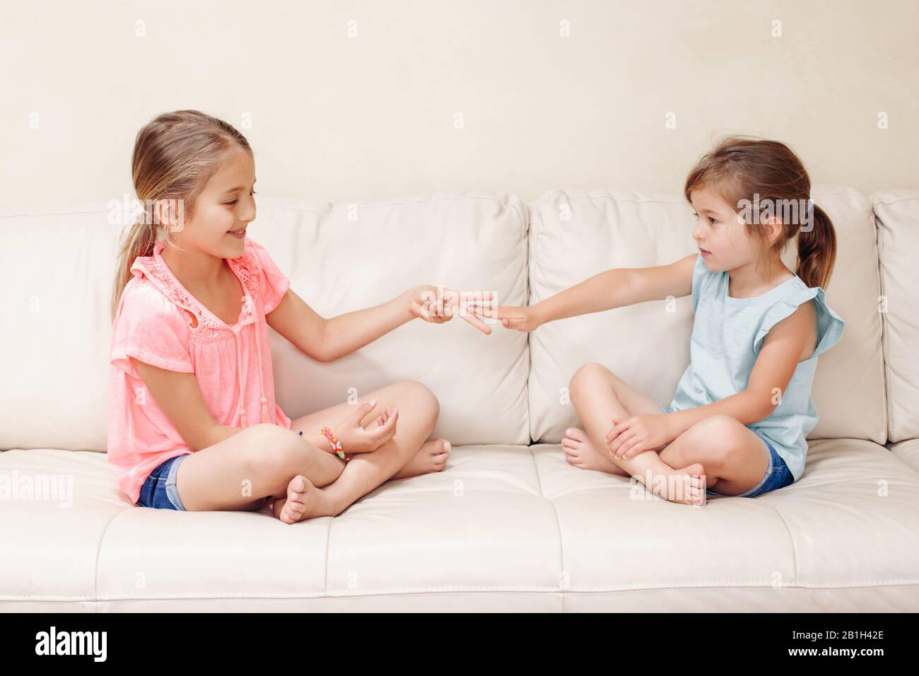 Two girls friends playing rock paper scissors hand game. Caucasian ...