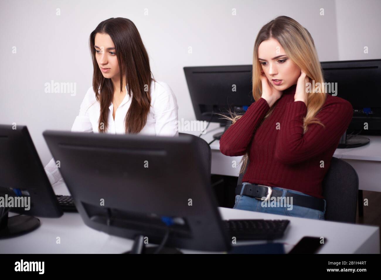Two female colleagues in office working together Stock Photo - Alamy