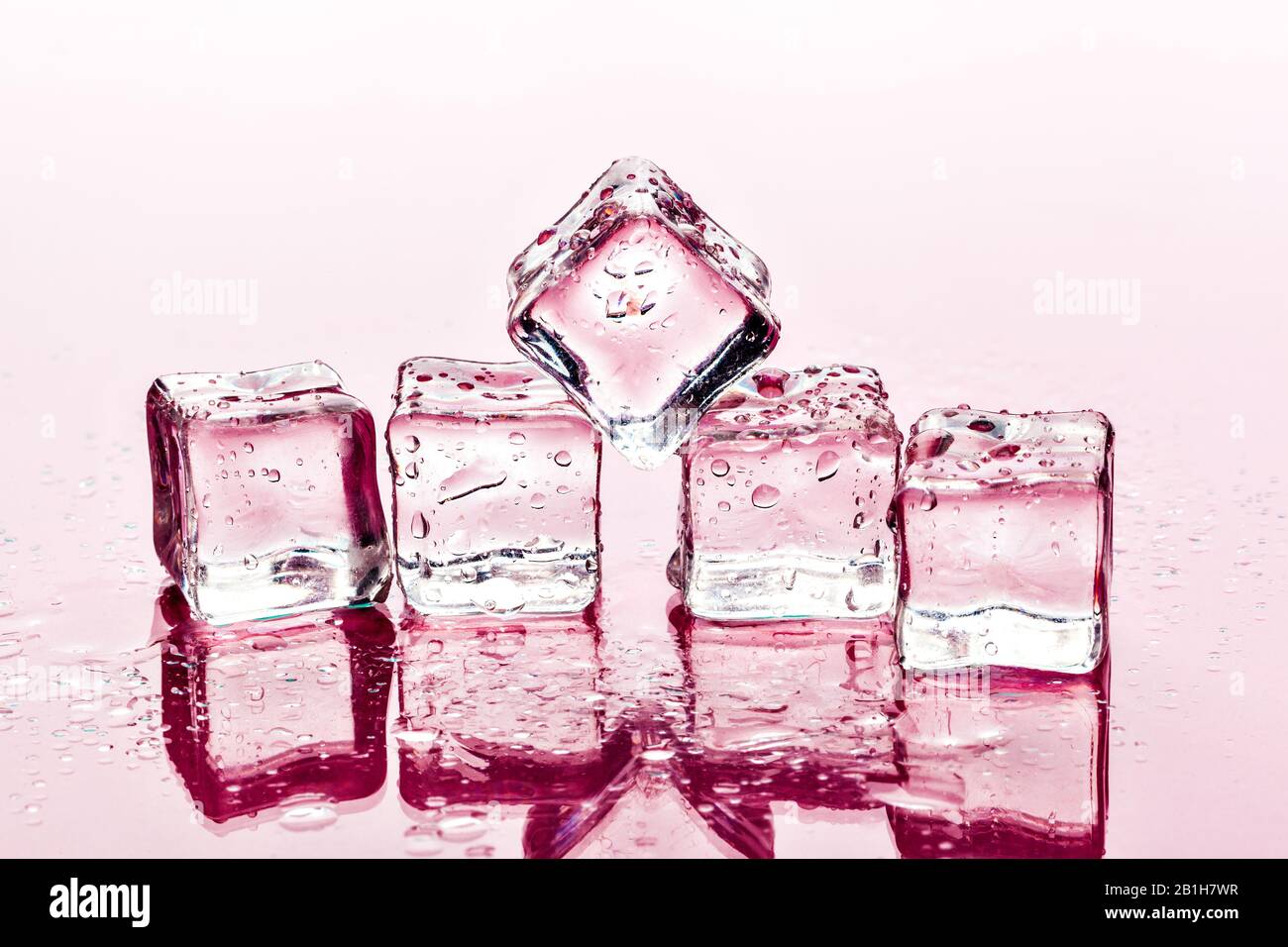 Ice cubes on pink background. Creative photo Stock Photo - Alamy