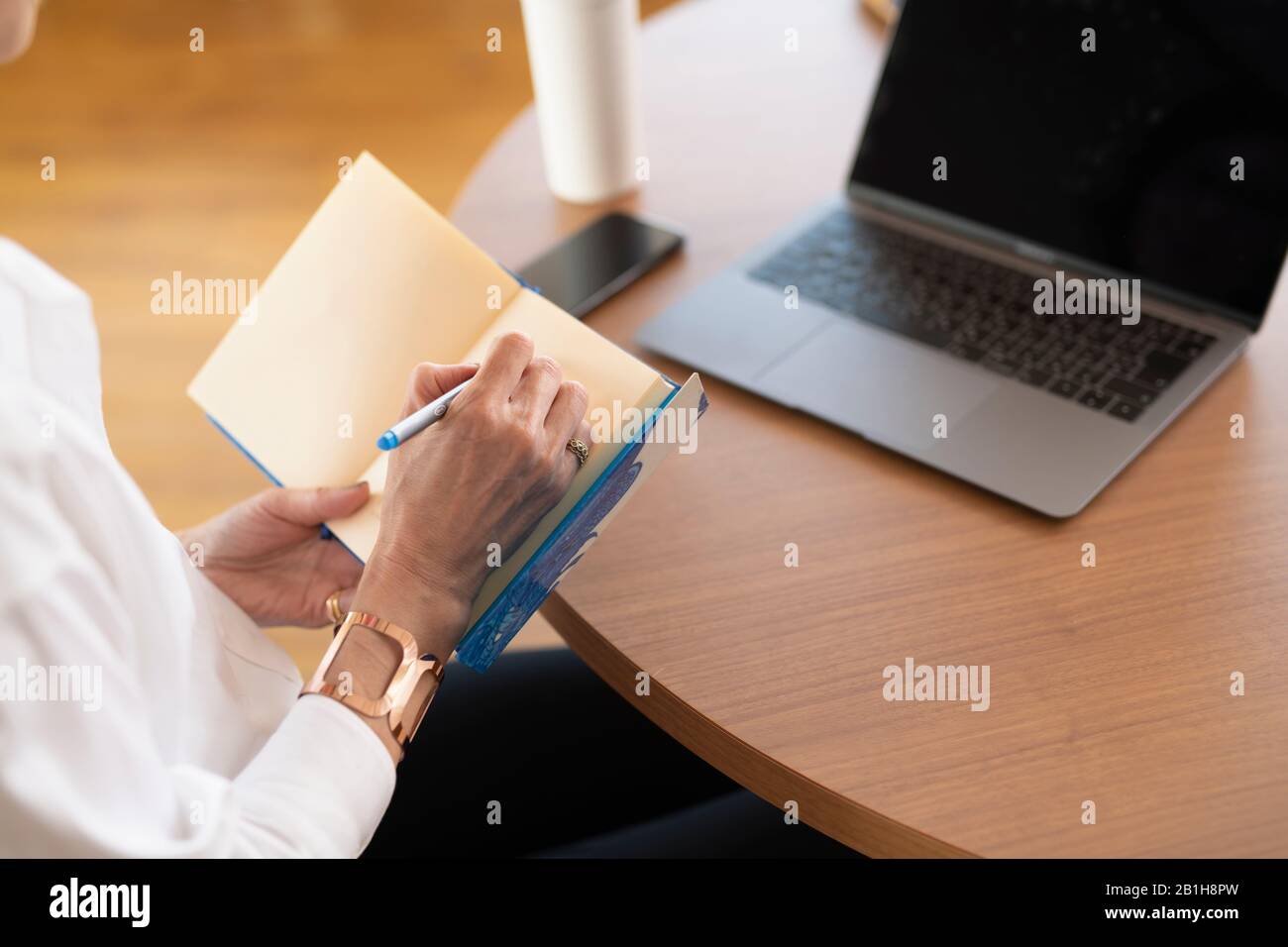 Hands of woman taking note in coworking office space Stock Photo - Alamy