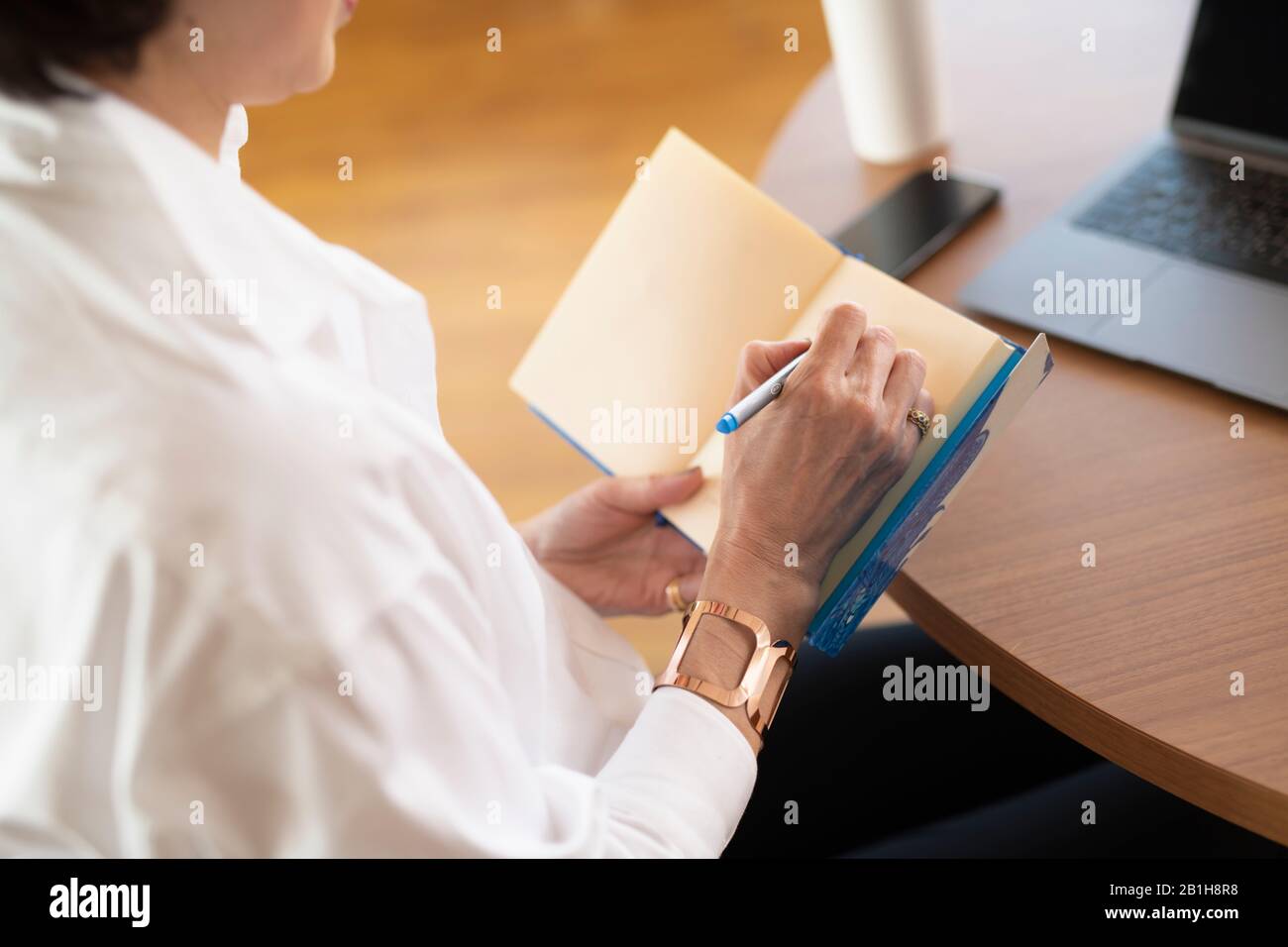 Hands of woman taking note in coworking office space Stock Photo - Alamy