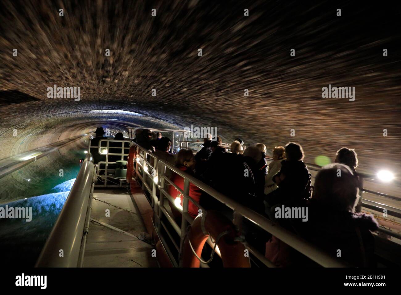 Passengers on a tour boat sailing inside of underground part of Saint ...