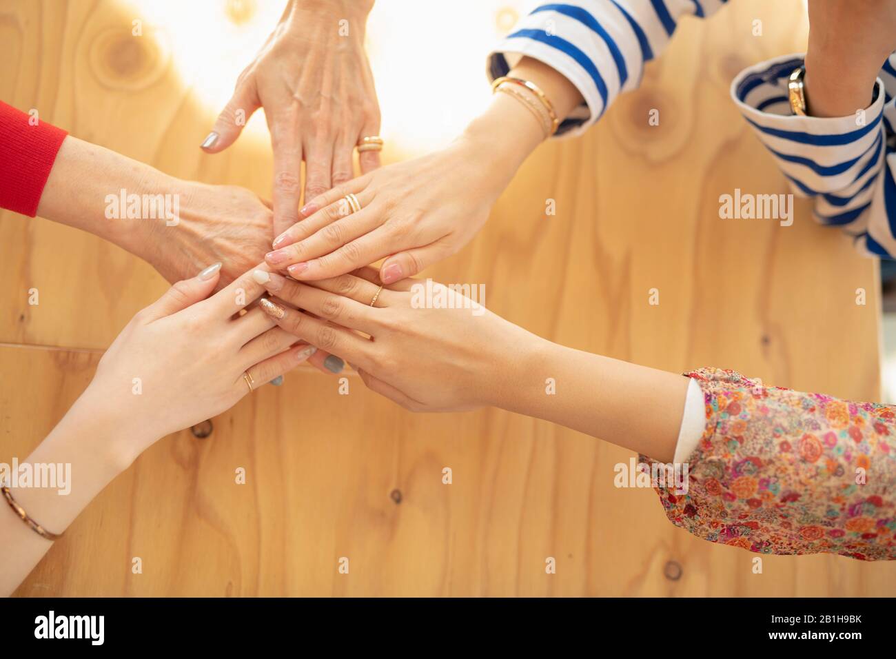 Hands putting together Stock Photo - Alamy