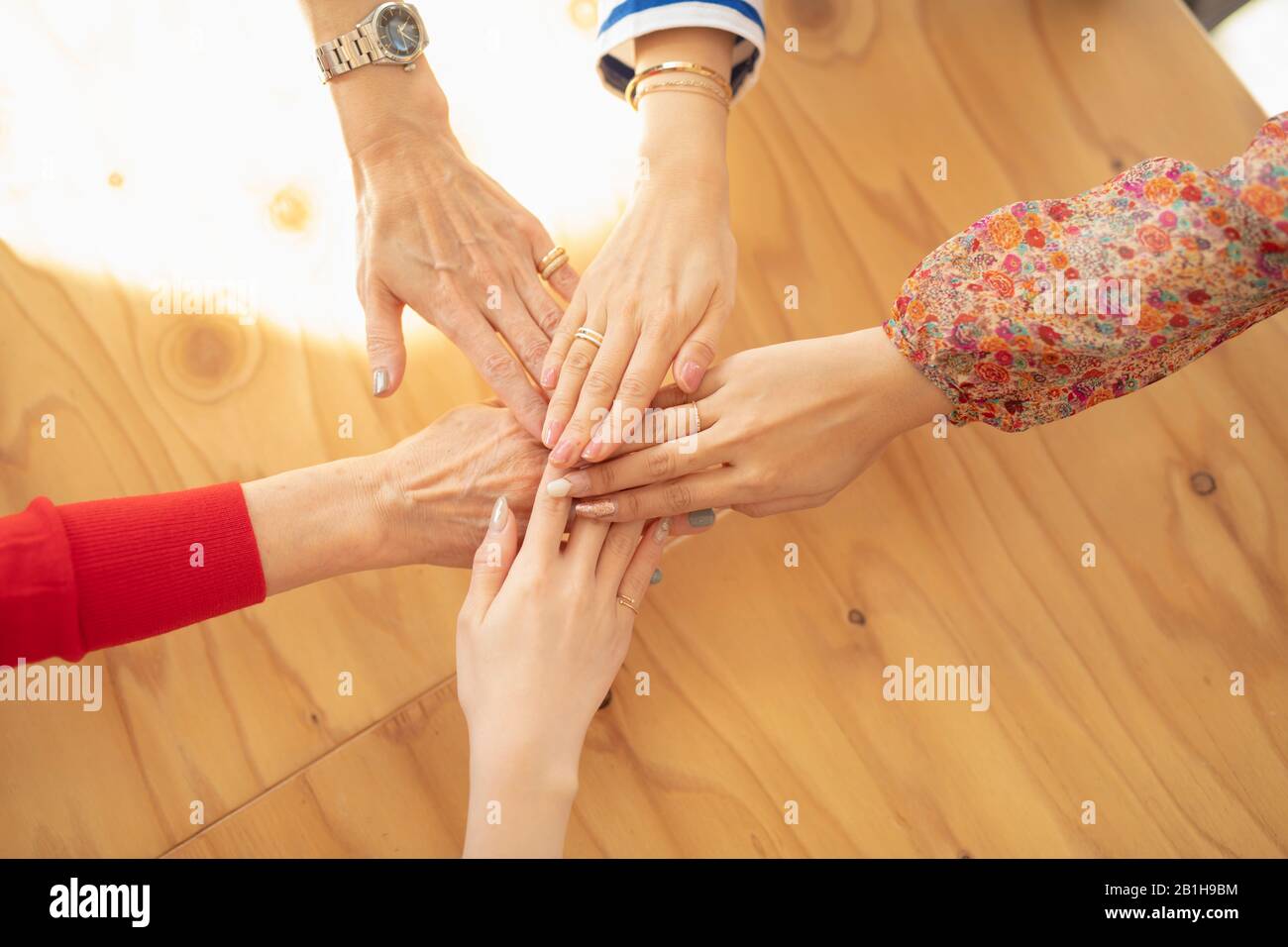 Hands putting together Stock Photo - Alamy