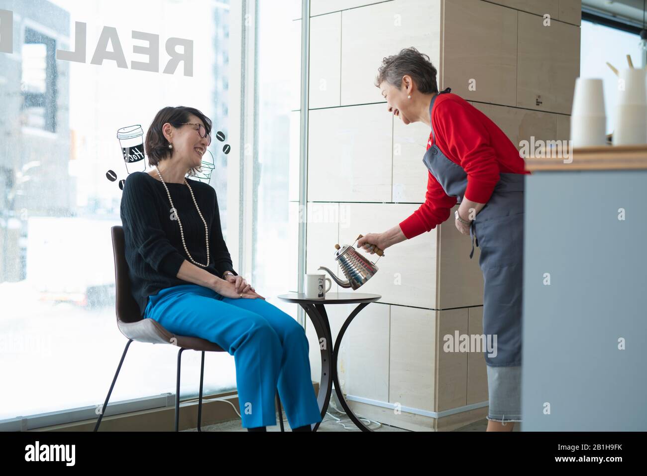 Attending to customer hi-res stock photography and images - Alamy