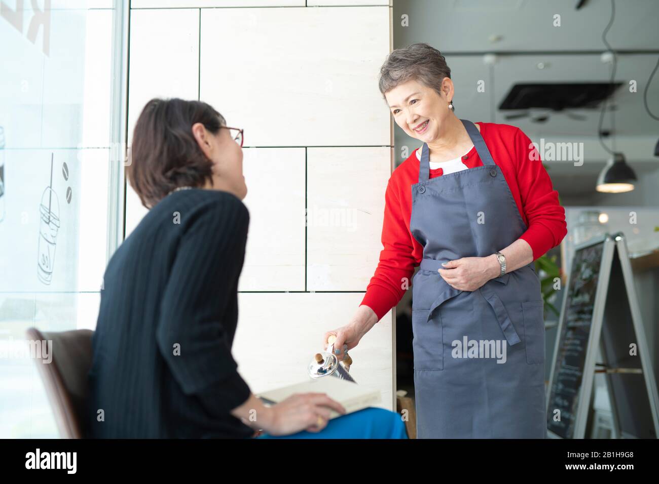 Attending to customer hi-res stock photography and images - Alamy