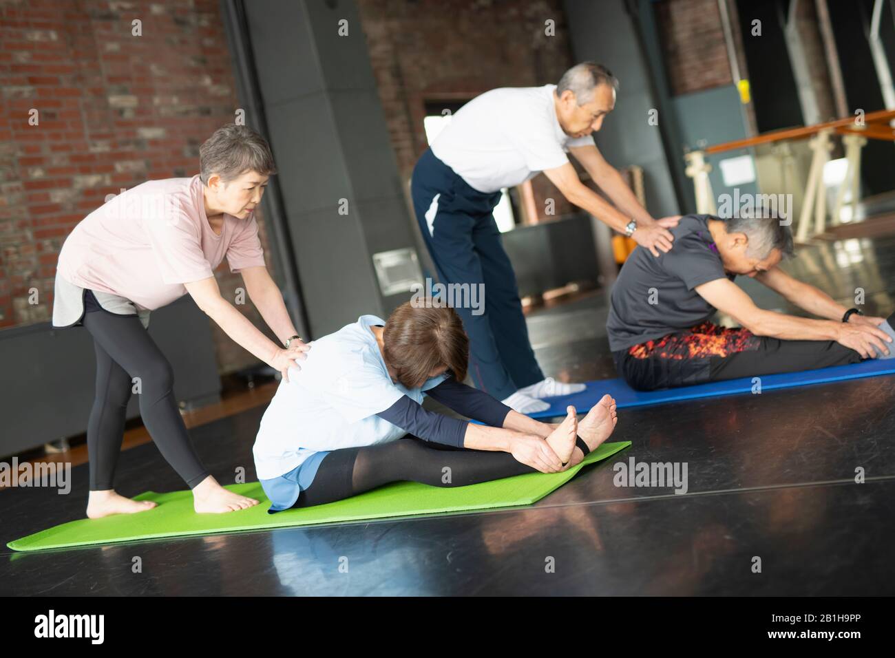 Four senior people stretching Stock Photo - Alamy