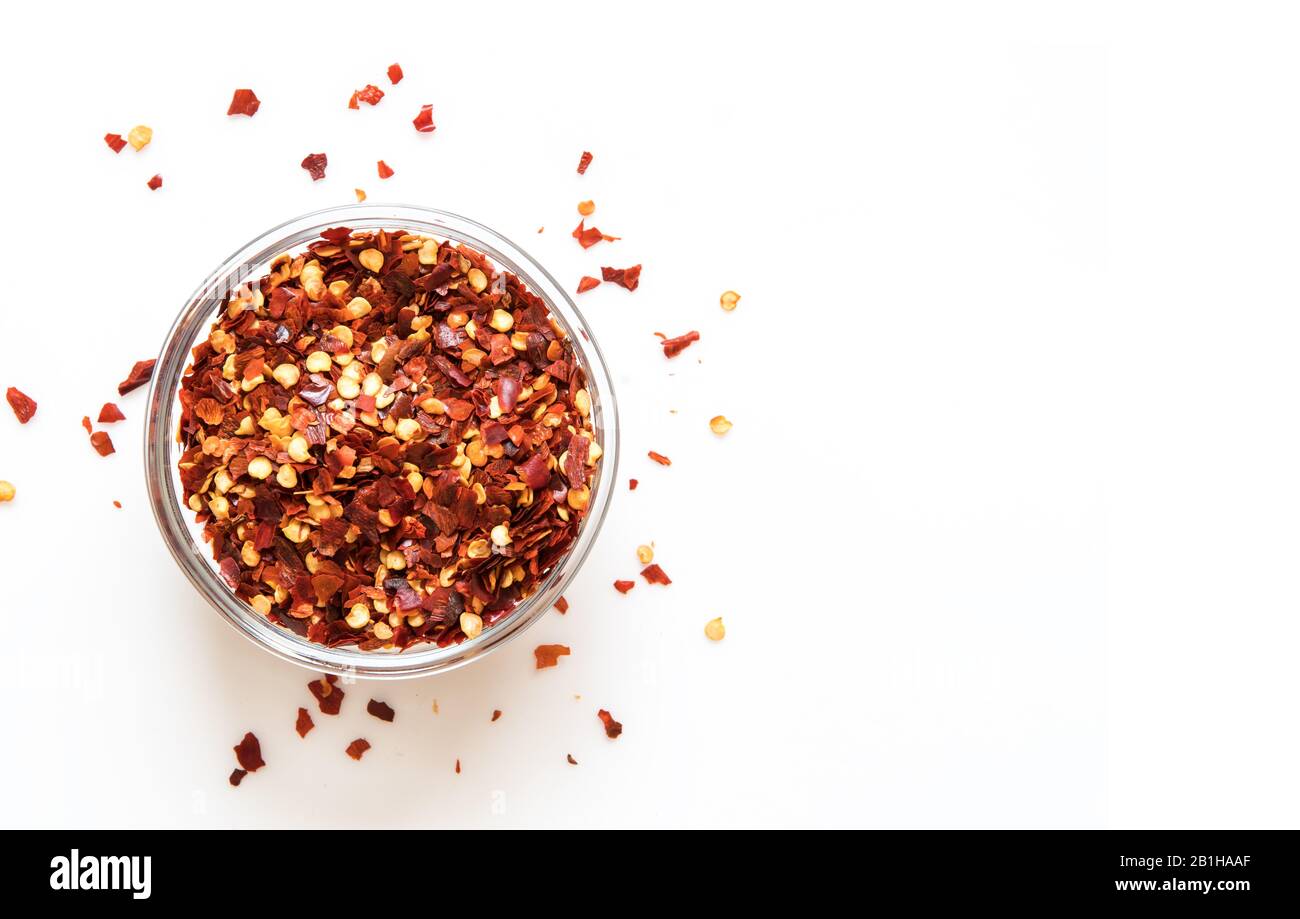 crushed red chili pepper in glass bowl. Top View on white background ...