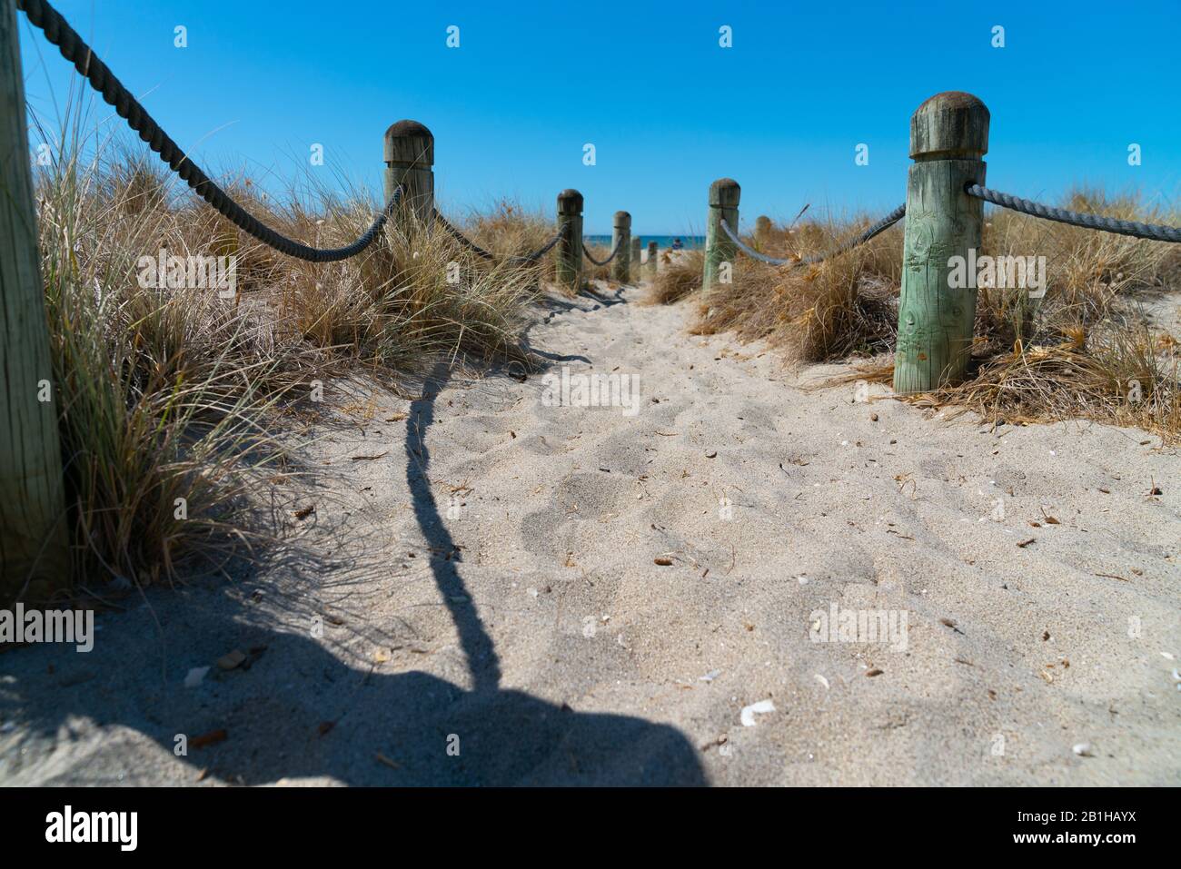 Beach access between rope and bollards across sand path at main beach ...