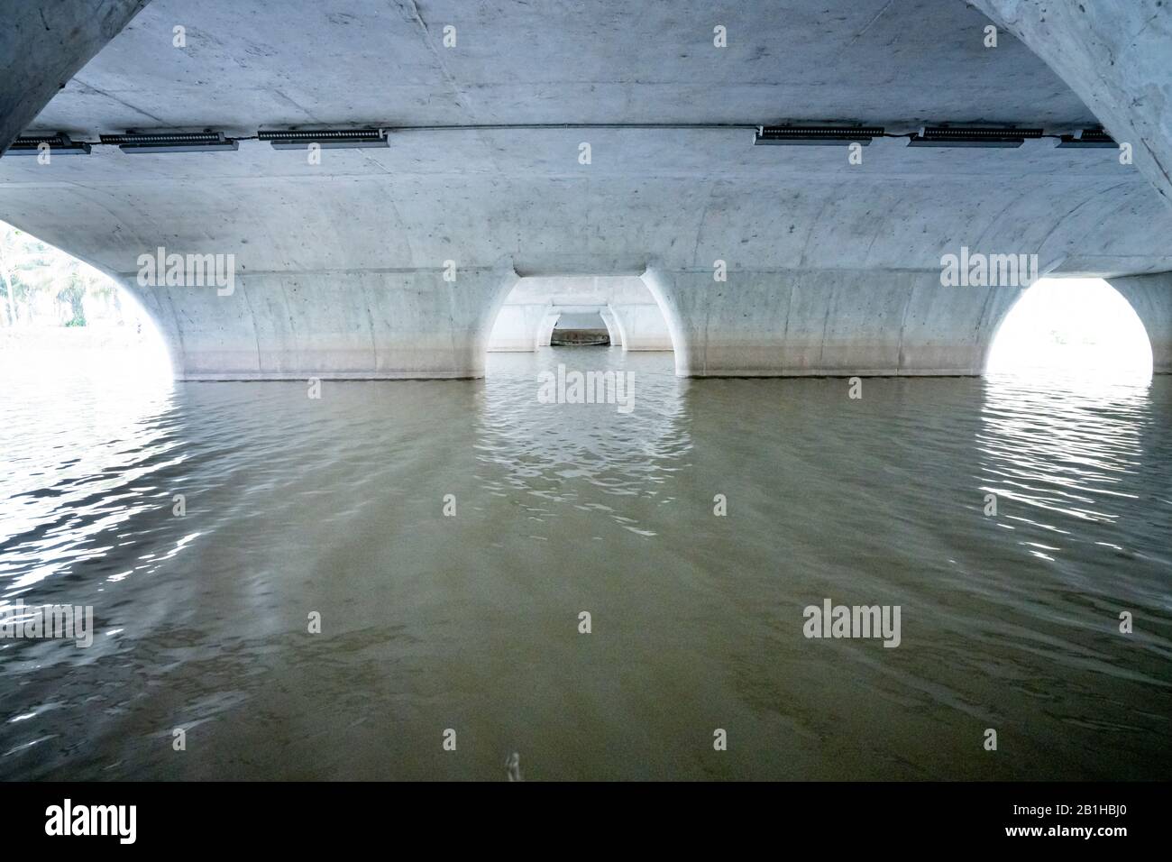 Curved Concrete Bridge over the water Stock Photo - Alamy