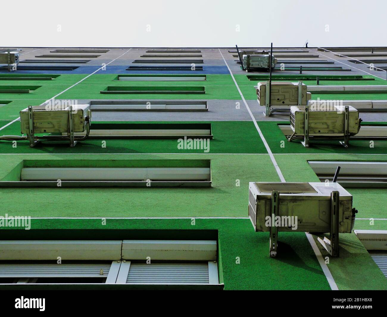 abstract view of room air conditioning units installed on green ...