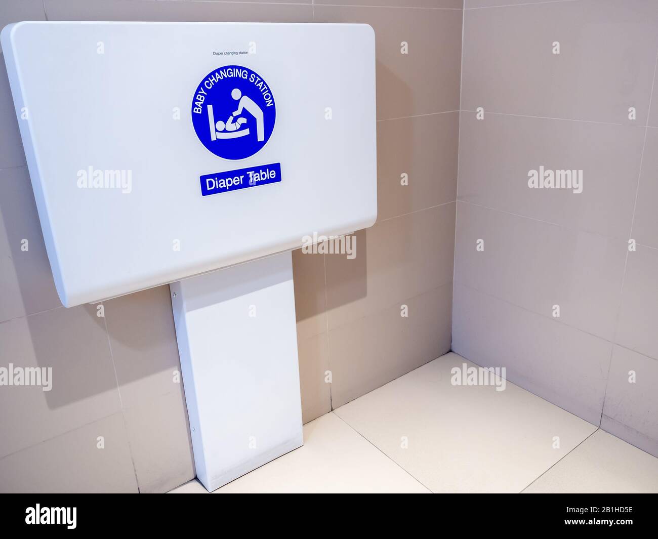 White diaper table changing station on the wall for baby changing ...