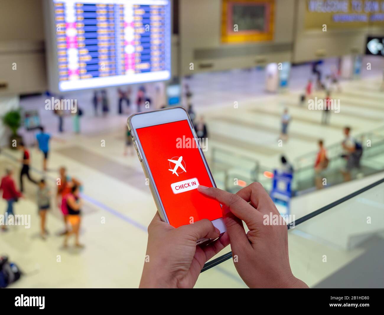Flight check-in by mobile phone. Hand touching on smartphone screen to ...