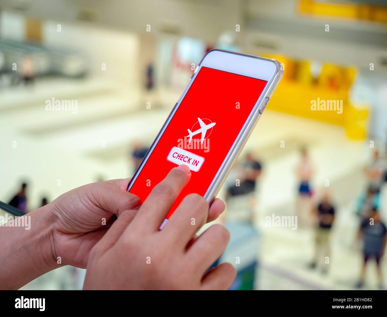 Flight check-in by mobile phone. Hand touching on smartphone screen to ...