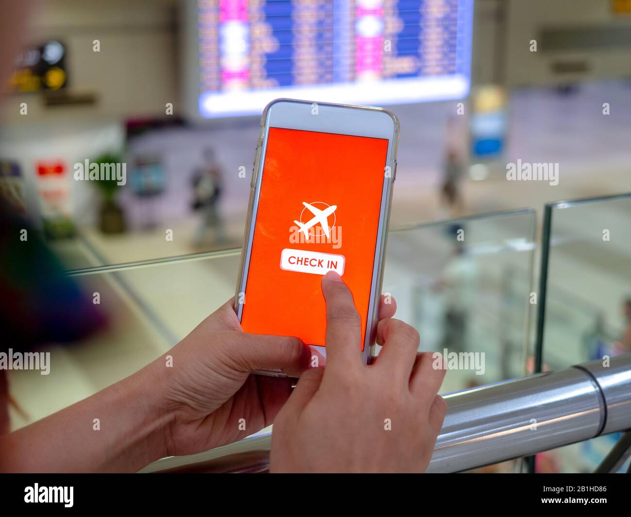 Flight check-in by mobile phone. Hand touching on smartphone screen to ...