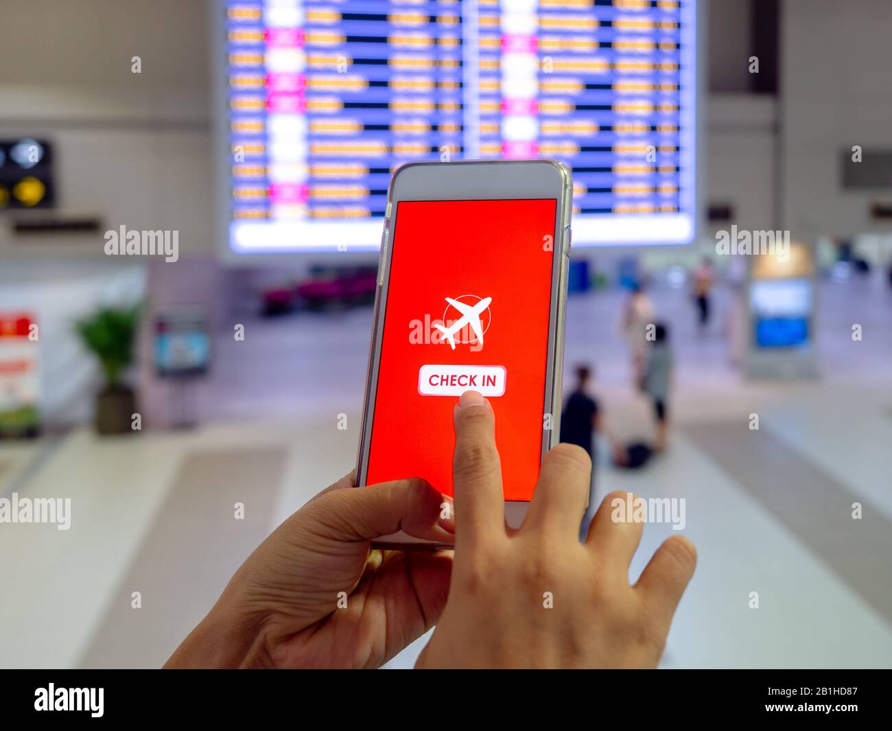 Flight check-in by mobile phone. Hand touching on smartphone screen to ...