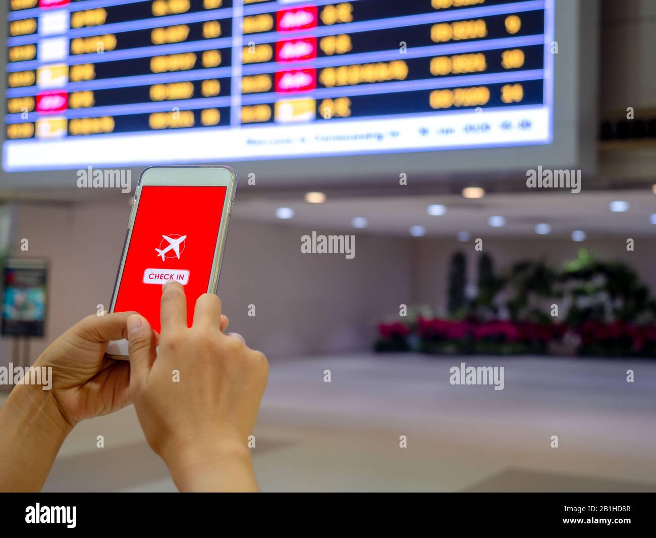 Flight check-in by mobile phone. Hand touching on smartphone screen to ...